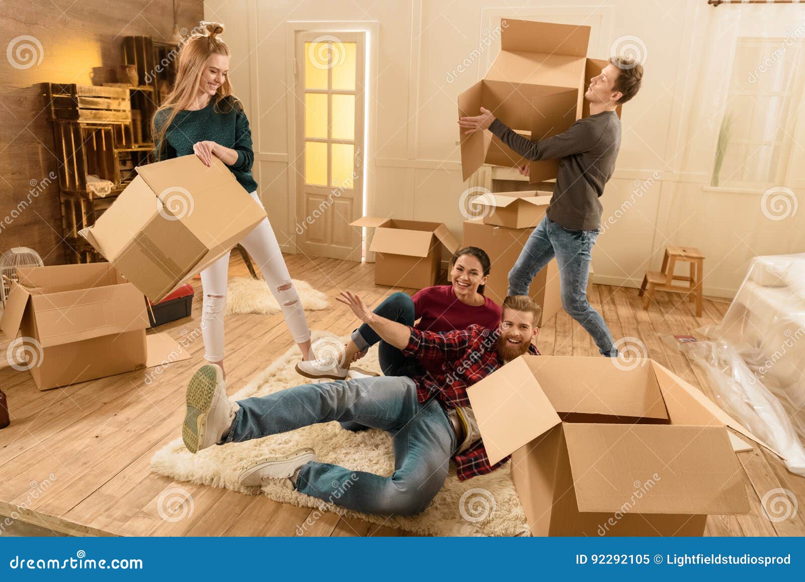 Friends Having Fun in New House while Unpacking Things Stock Image ...