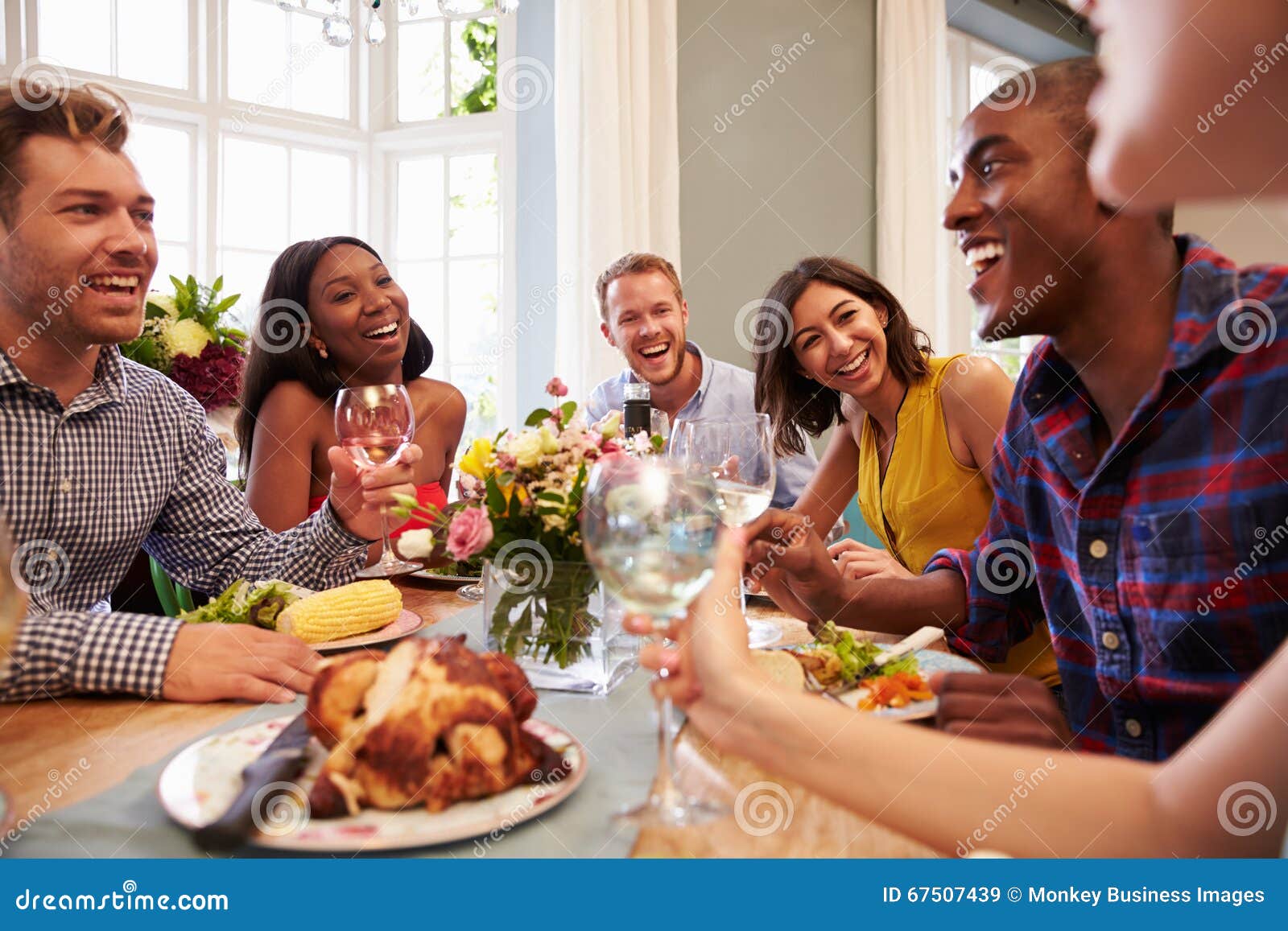 Friends at Home Sitting Around Table for Dinner Party Stock Image ...