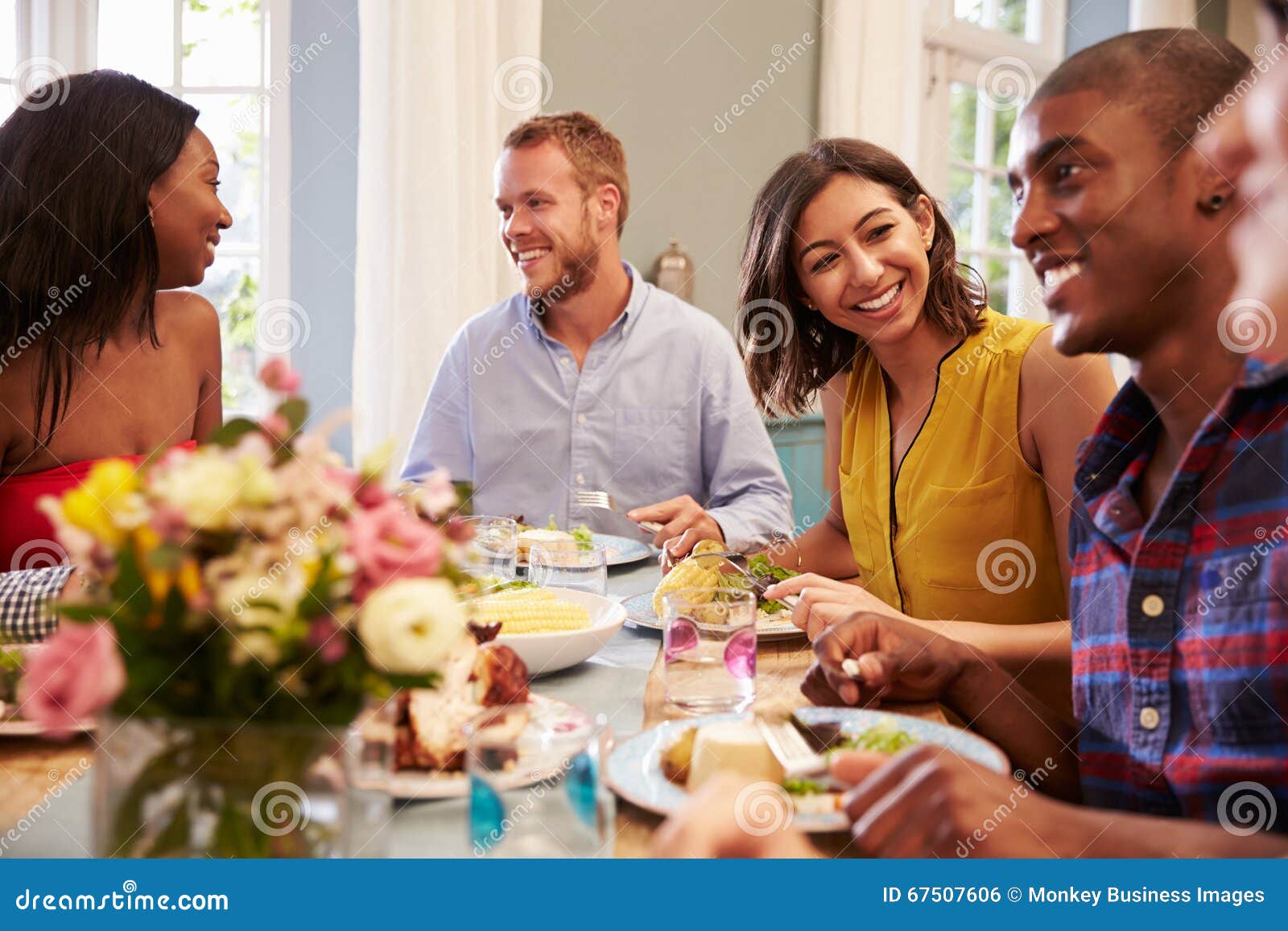 Friends at Home Sitting Around Table for Dinner Party Stock Photo ...