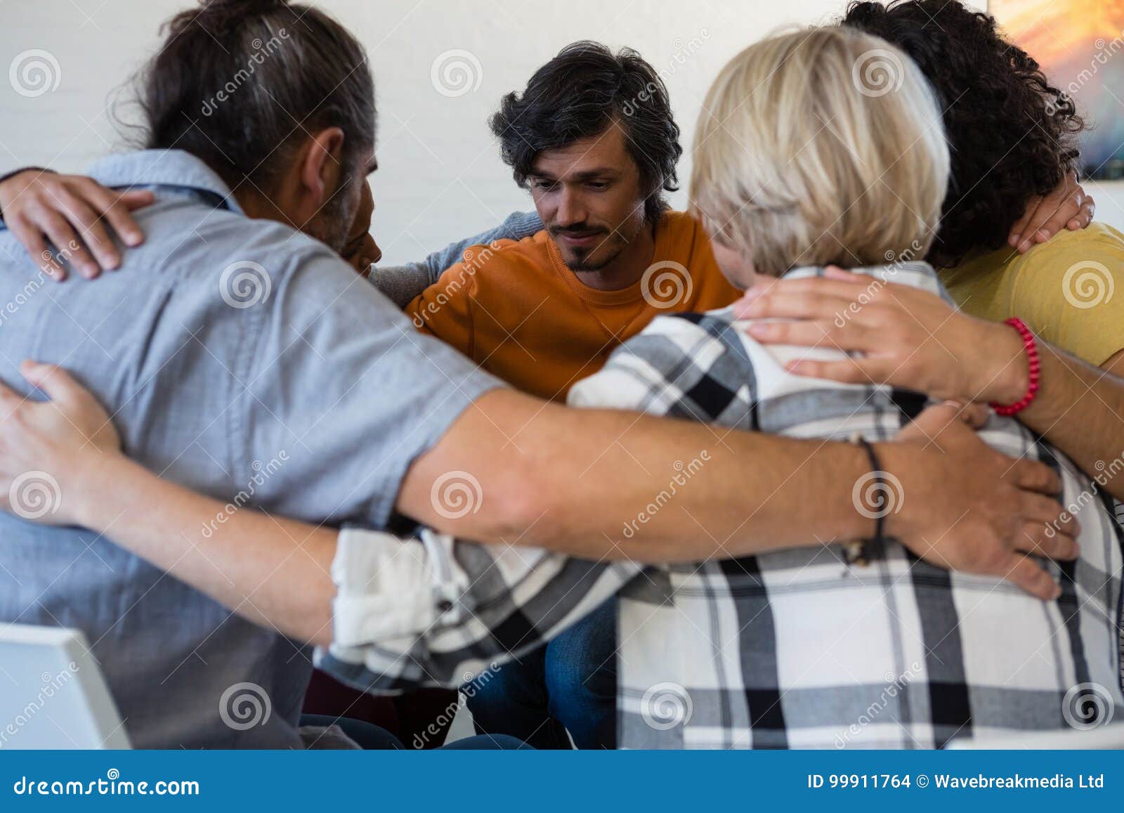 Friends Huddling while Sitting on Chair Stock Photo - Image of bonding ...