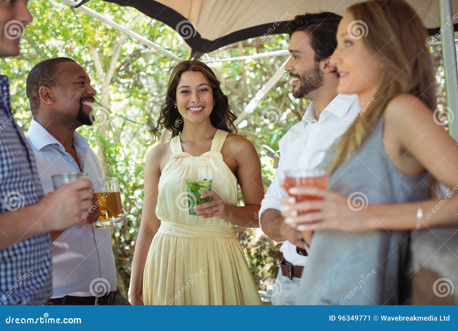 Friends Interacting while Having a Alcohol at Counter Stock Image ...