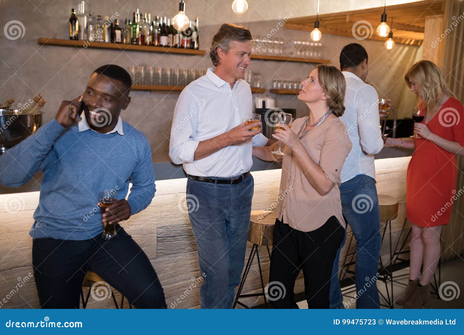 Friends Interacting while Having Drinks at Counter Stock Image - Image ...