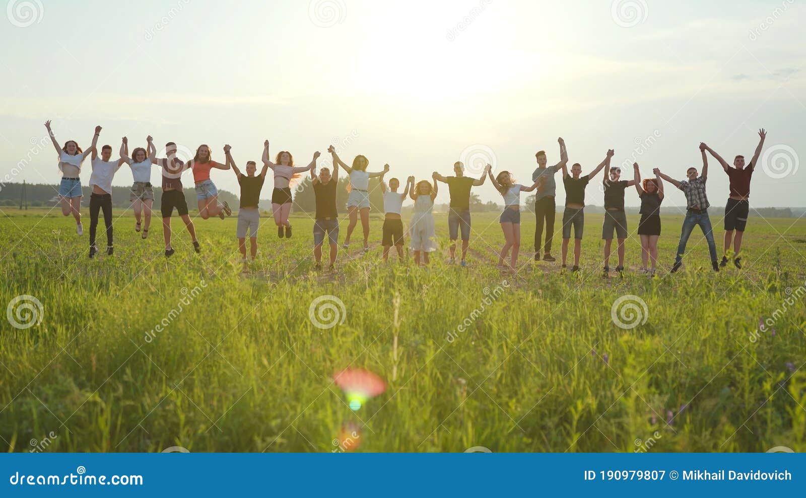 Friends are Jumping Holding Hands at Sunset. Stock Image - Image of ...