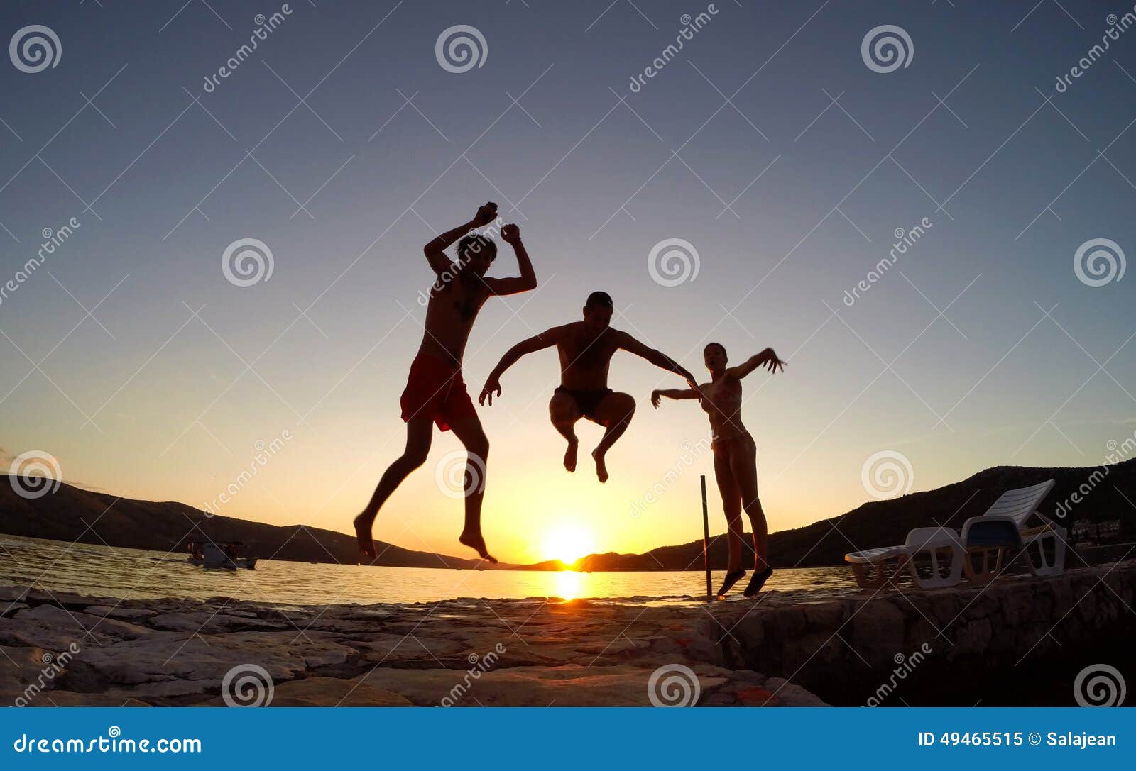 Friends Jumping at Sunset on the Beach Stock Image - Image of ...