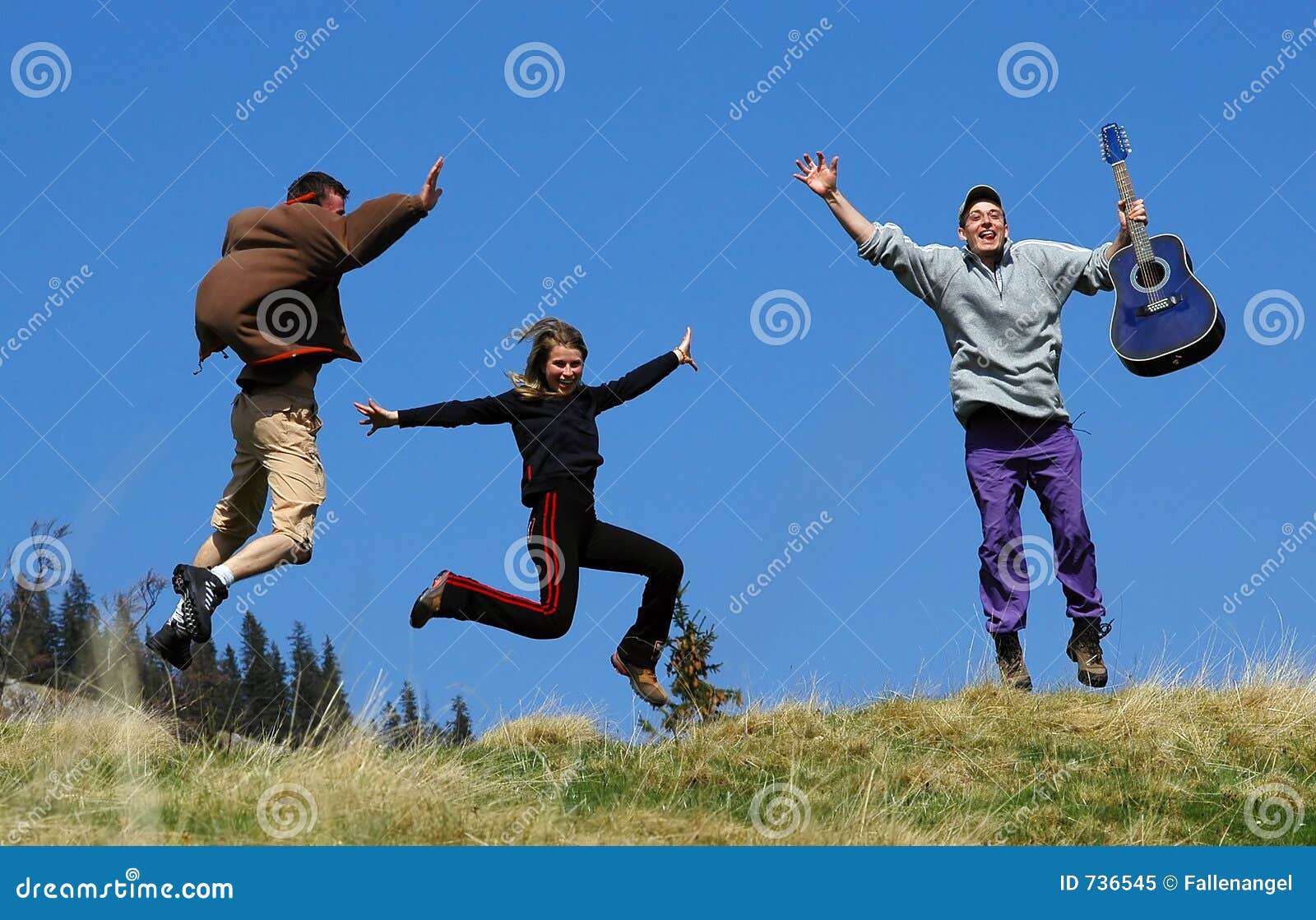 Friends Jumps Over a Grass Field on Mountain Stock Image - Image of ...