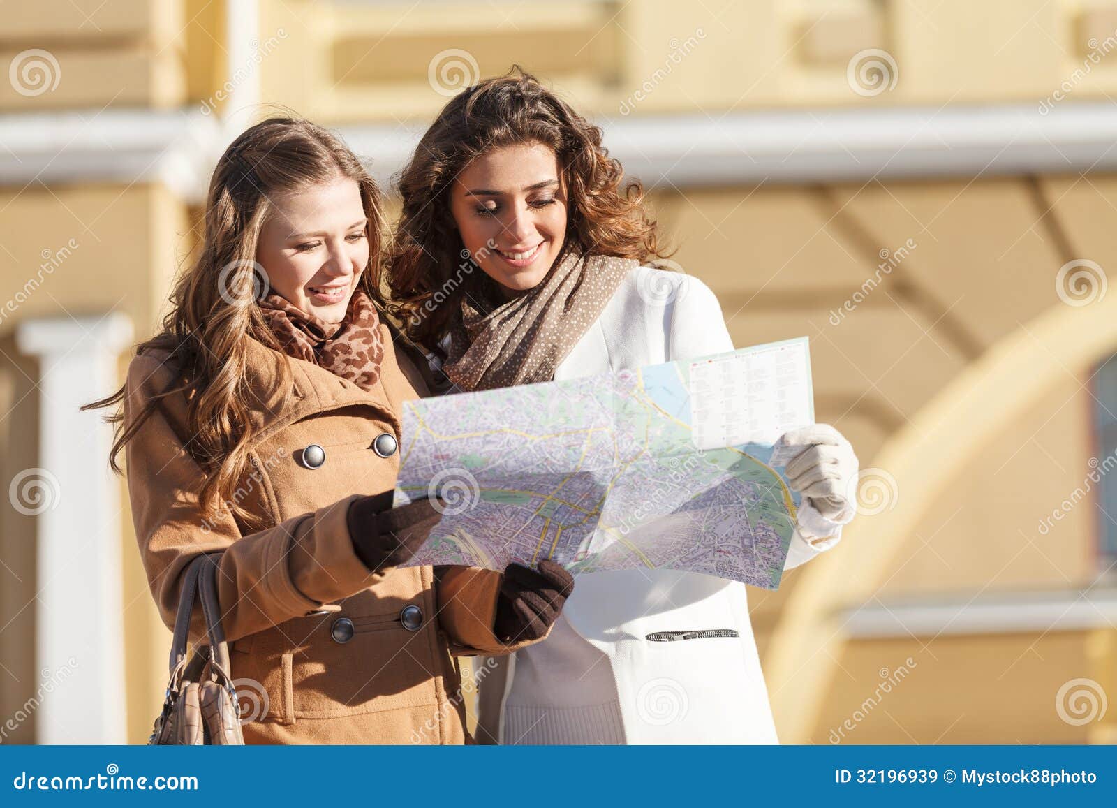 Friends Looking at the Map. Two Beautiful Young Women Looking in Stock ...