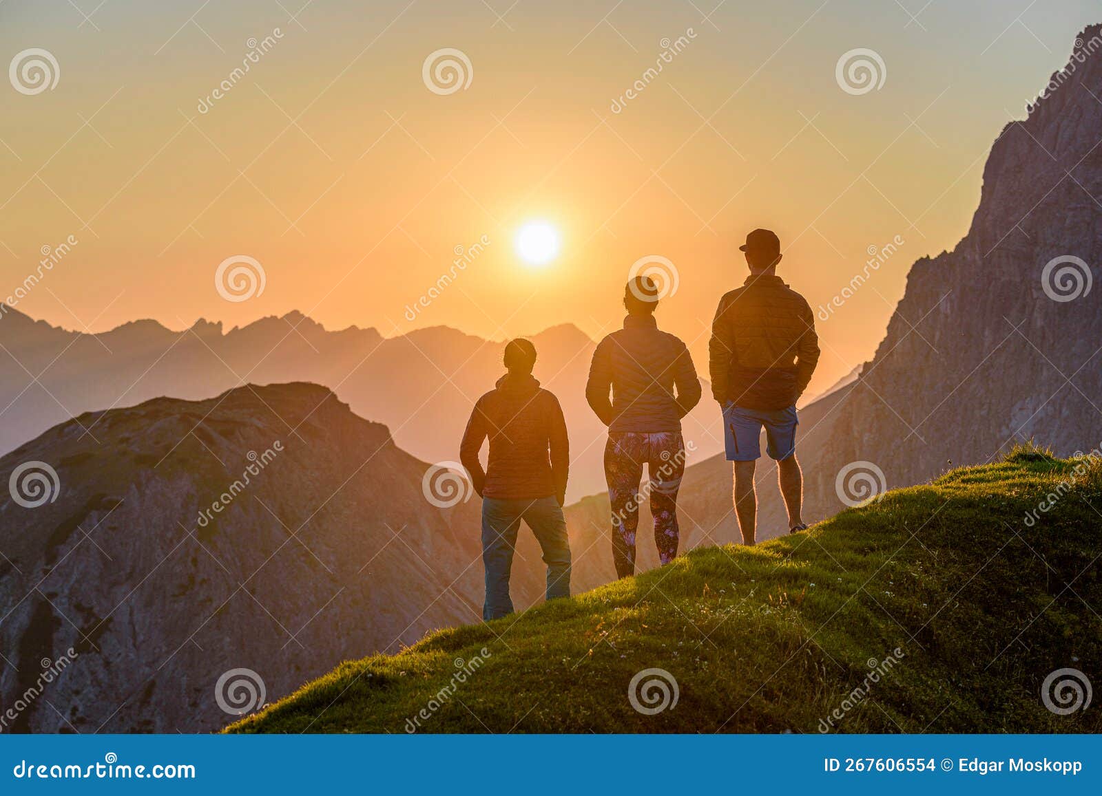 3 Friends Looking at Sunset in the Mountains Stock Photo - Image of ...