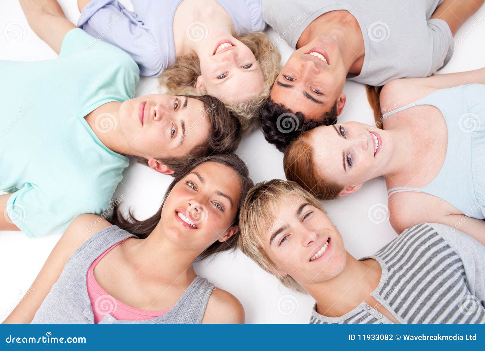 Friends Lying on Floor with Heads Together Stock Photo - Image of ...