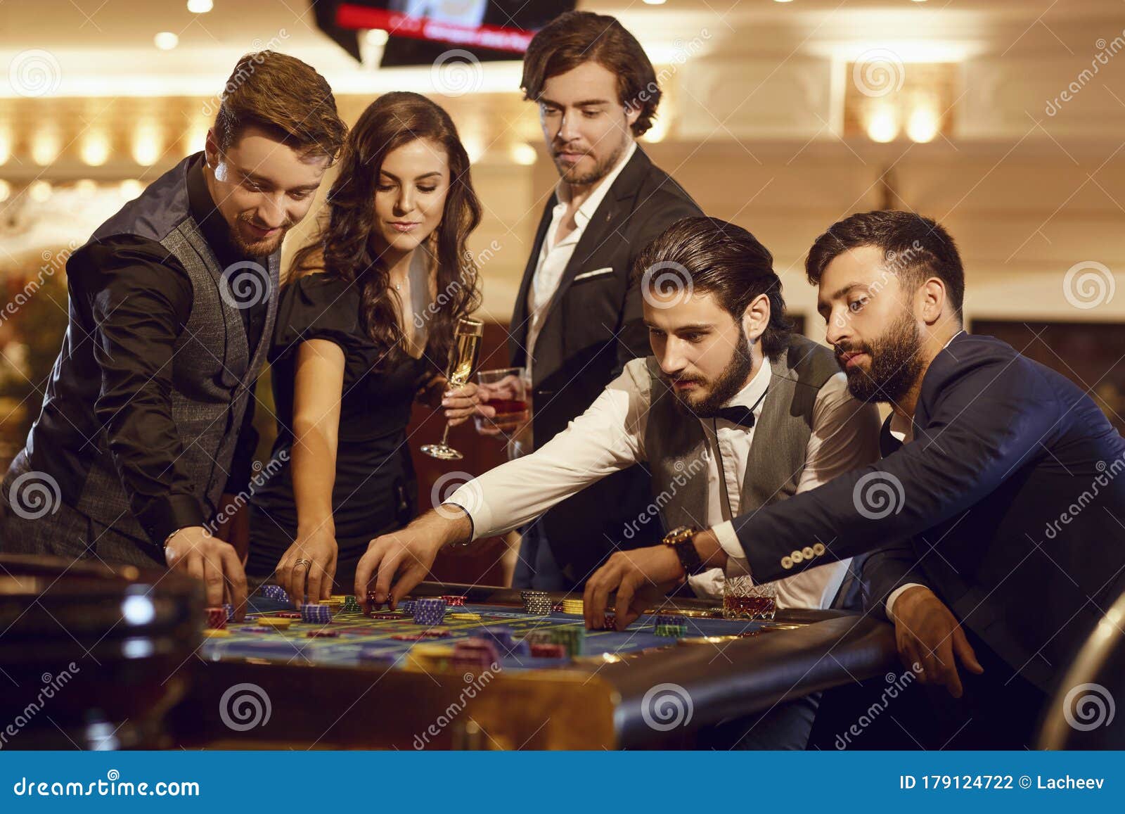 Friends Make Bets Gambiling at the Roulette Table in the Casino. Stock ...