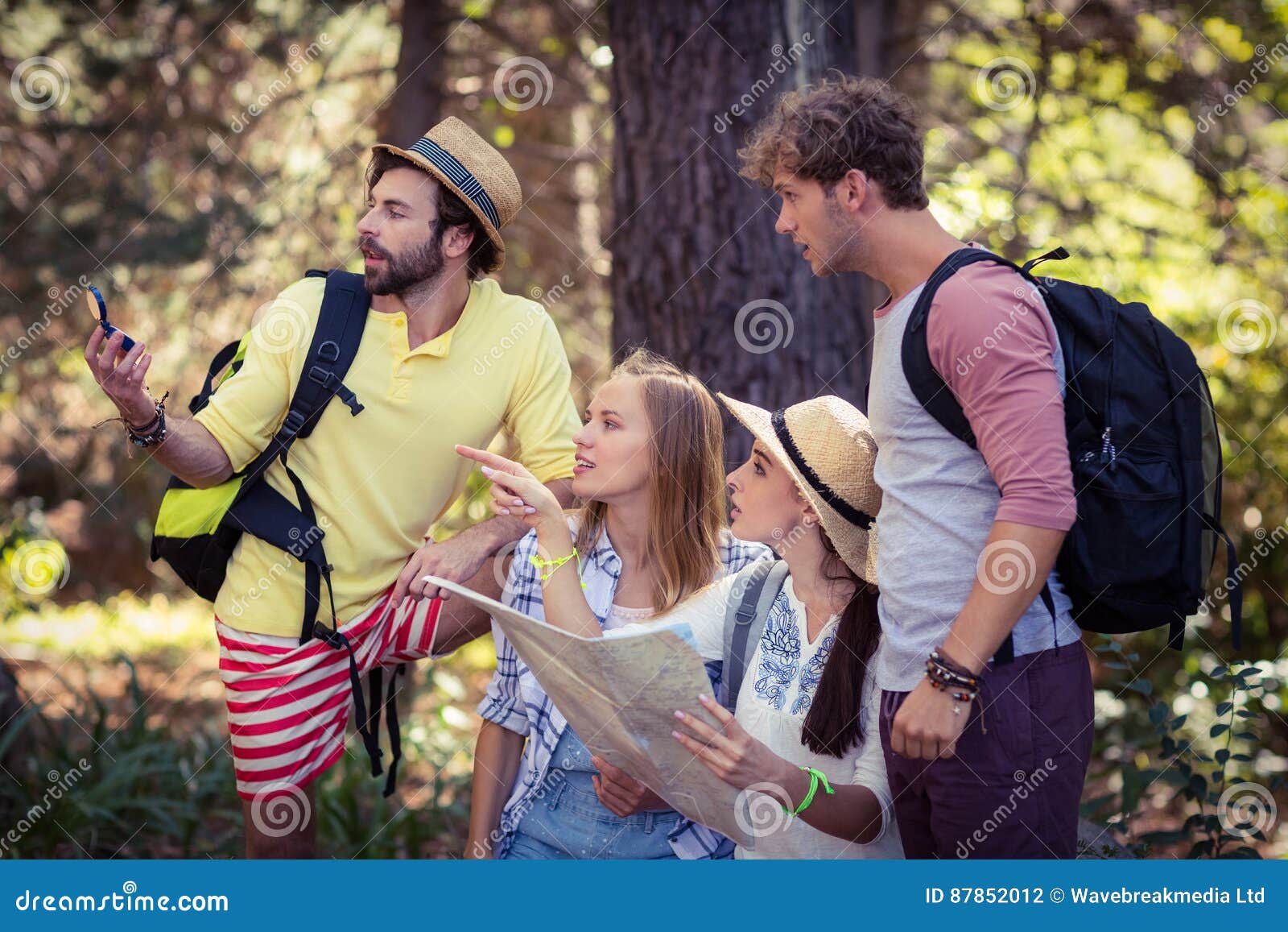 Friends with a Map Looking at a Direction Stock Photo - Image of ...