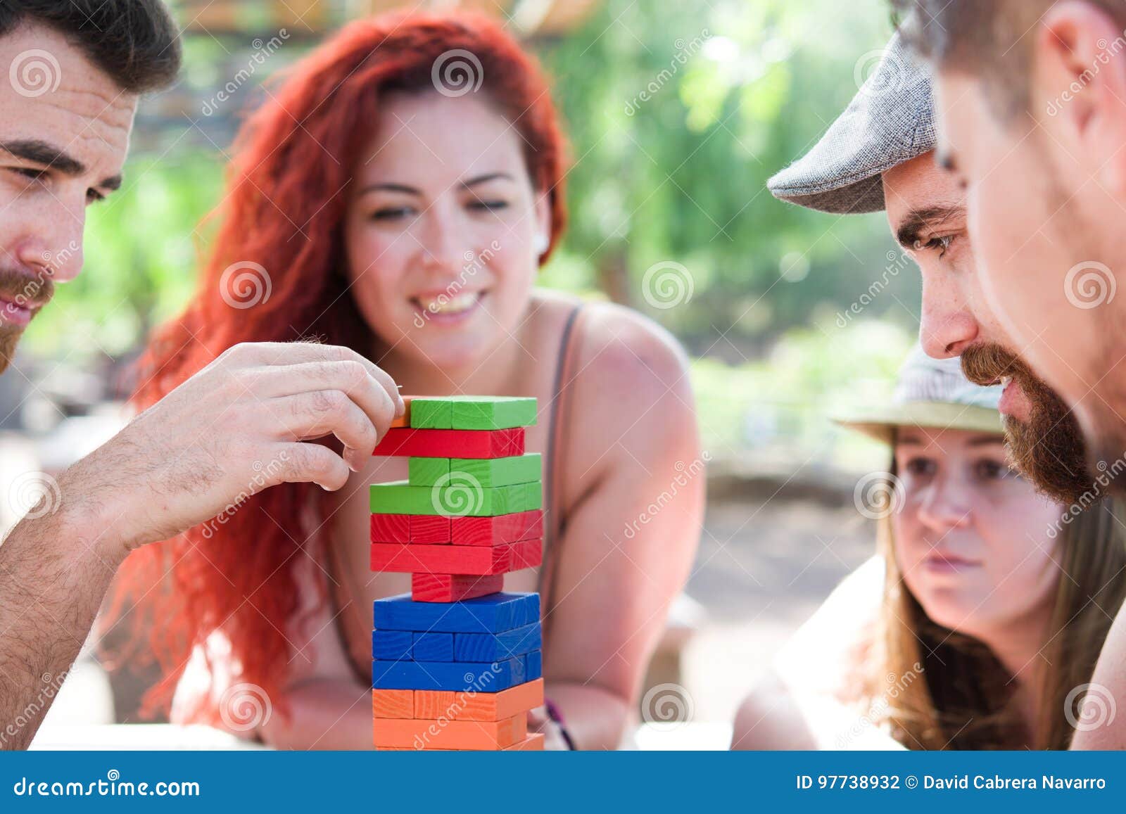 Friends playing block game stock photo. Image of people - 97738932