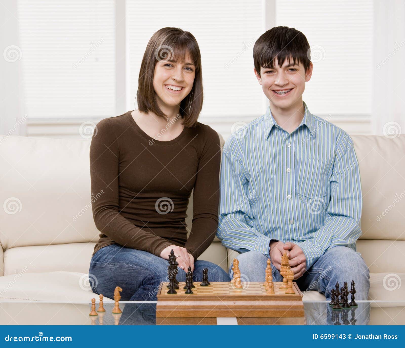 Friends Playing Chess in Livingroom Stock Image - Image of male, female ...