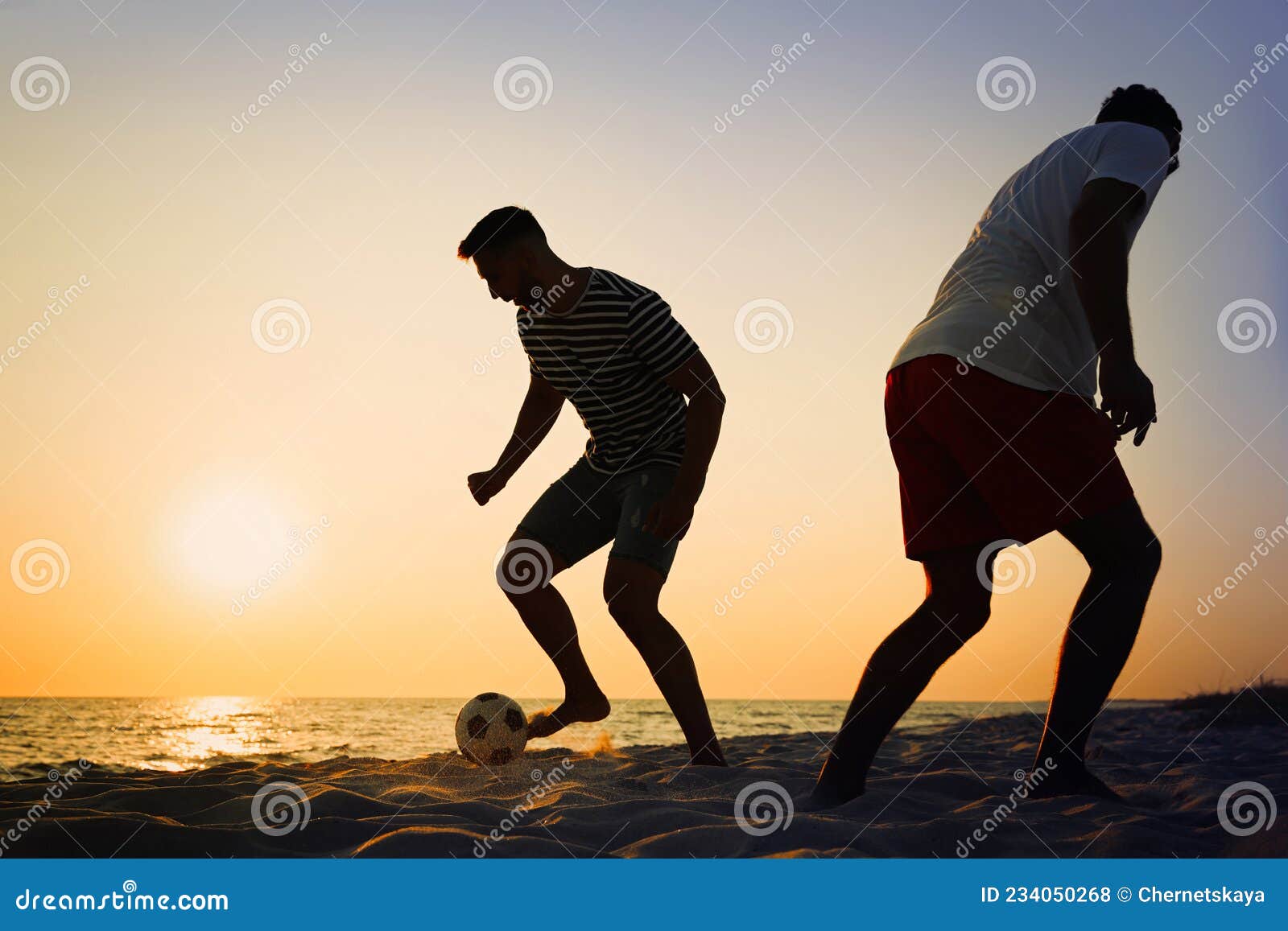 Friends Playing Football on Beach at Sunset Stock Photo - Image of ...
