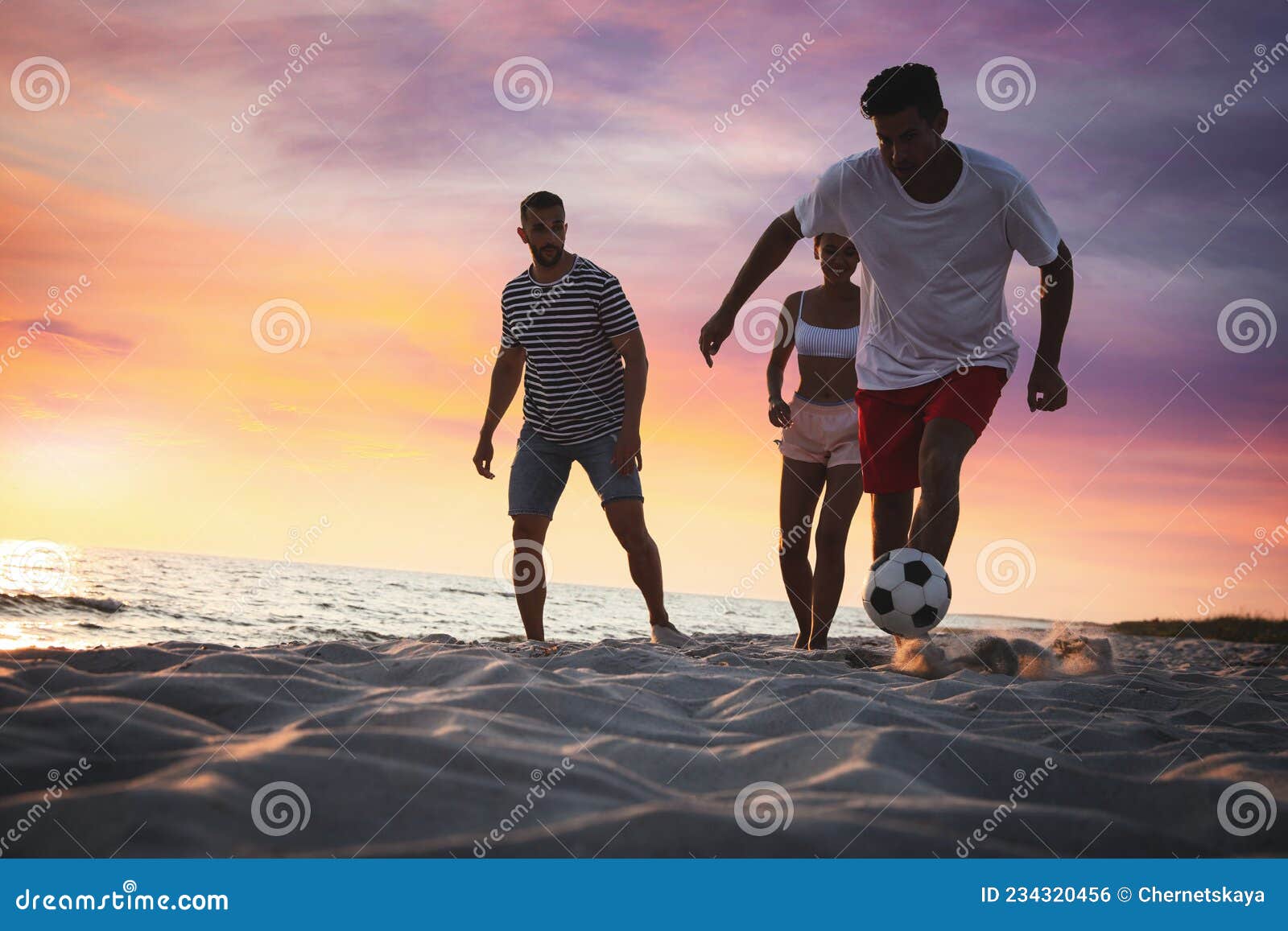 Friends Playing Football on Beach at Sunset Stock Photo - Image of ball ...