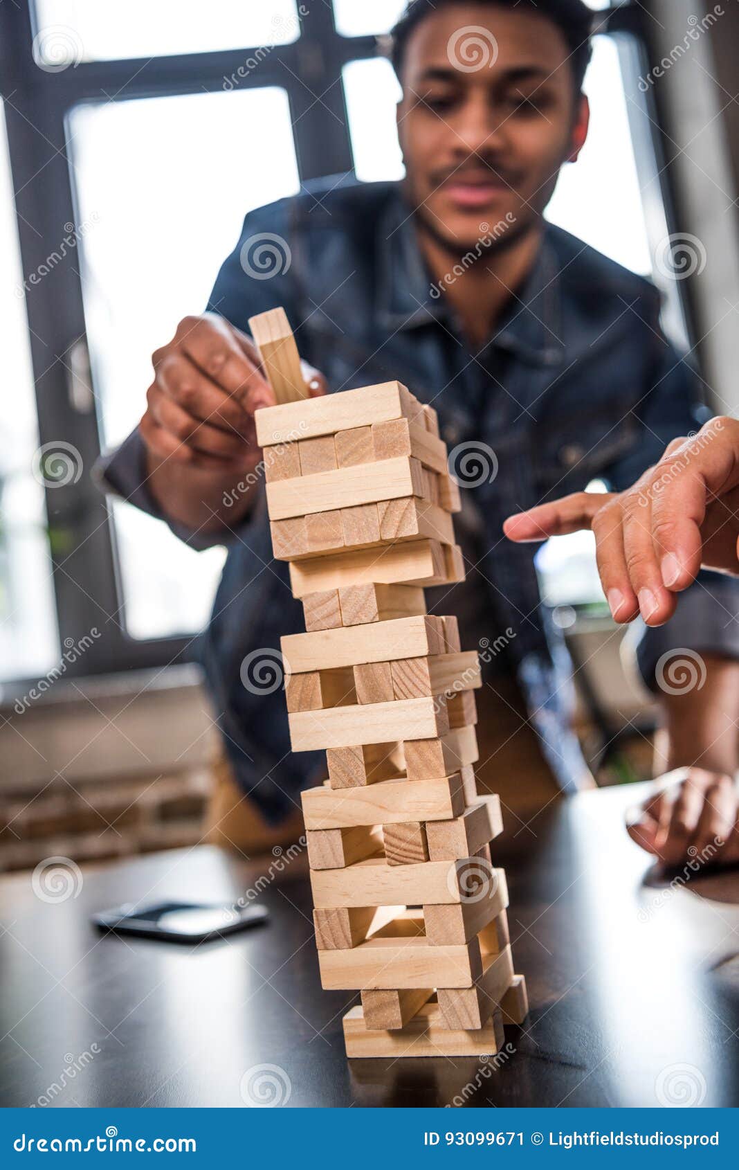Friends playing jenga game stock image. Image of relationship - 93099671