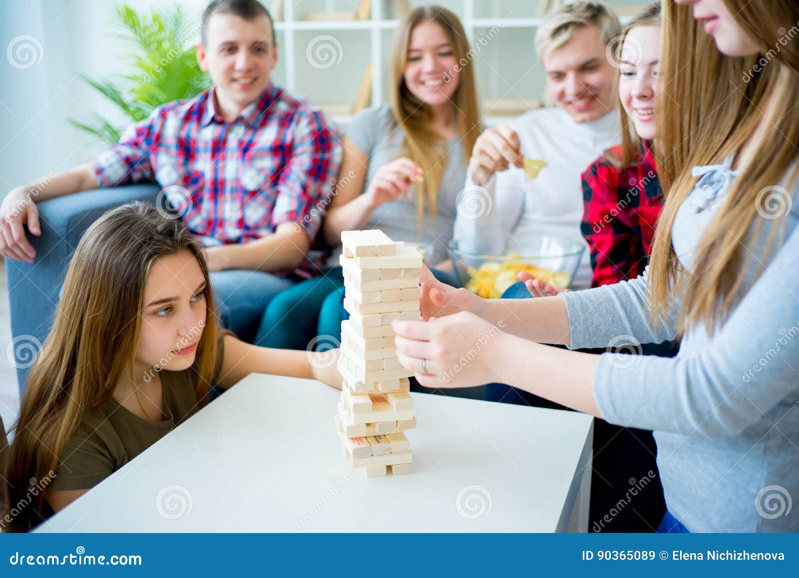 Friends playing jenga stock image. Image of board, together - 90365089