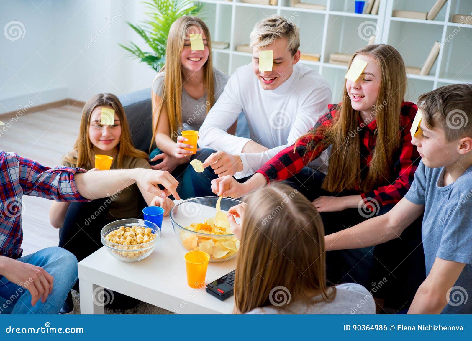 Friends playing stickers stock photo. Image of seated - 90364986