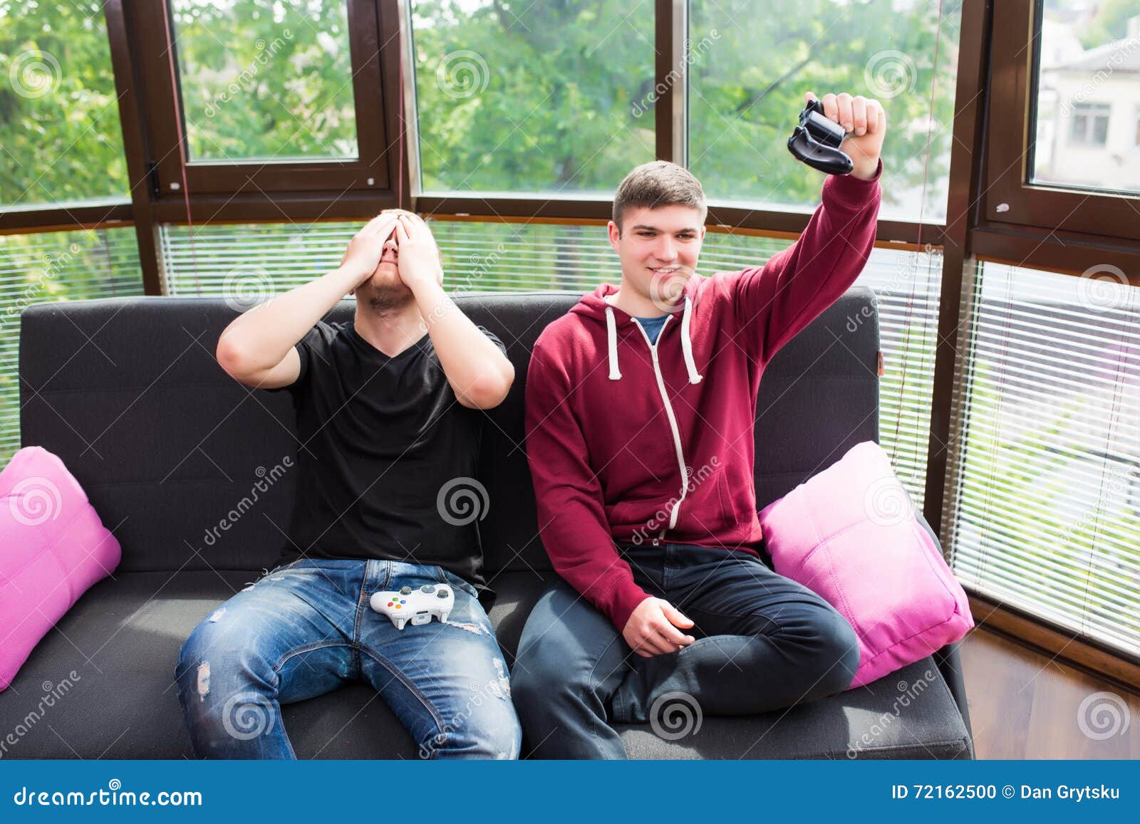 Friends in Playing Video Games Stock Photo - Image of chilling, looking ...