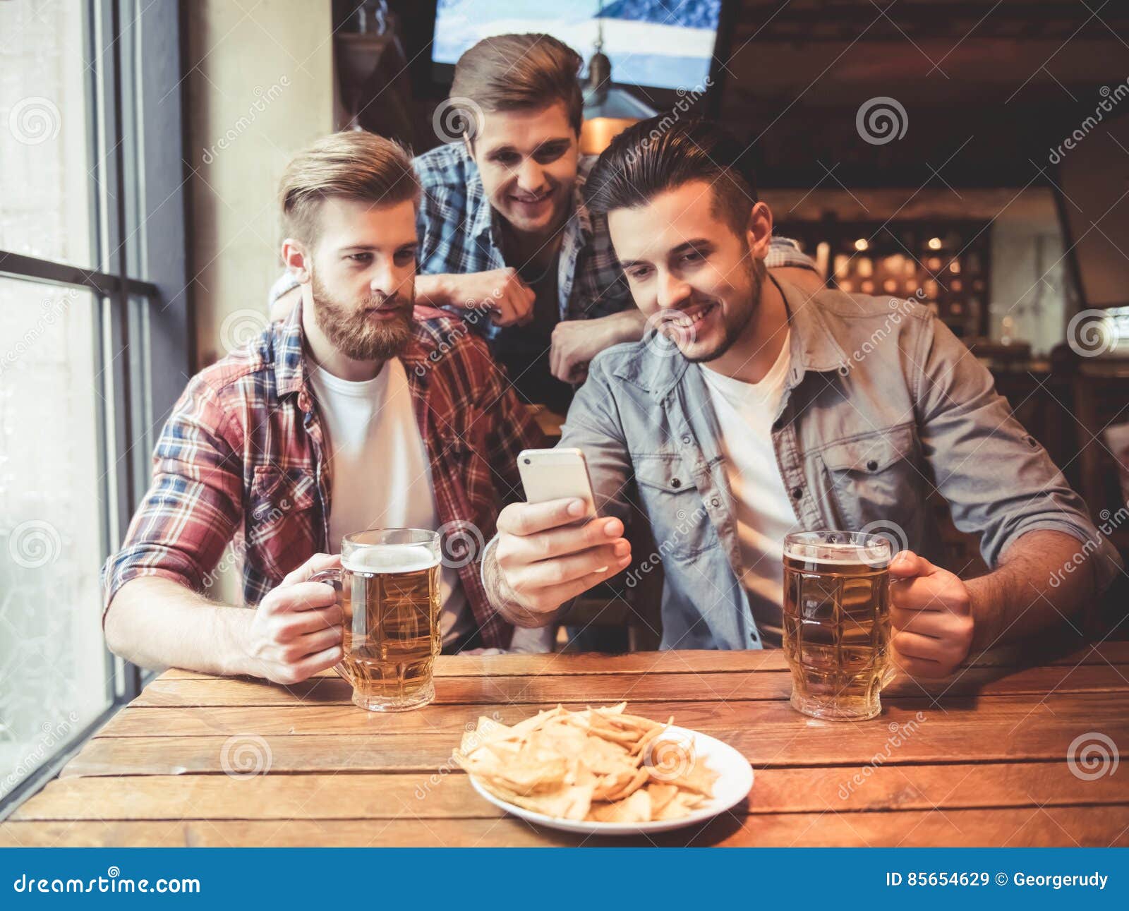 Friends at the pub stock image. Image of alcohol, people - 85654629