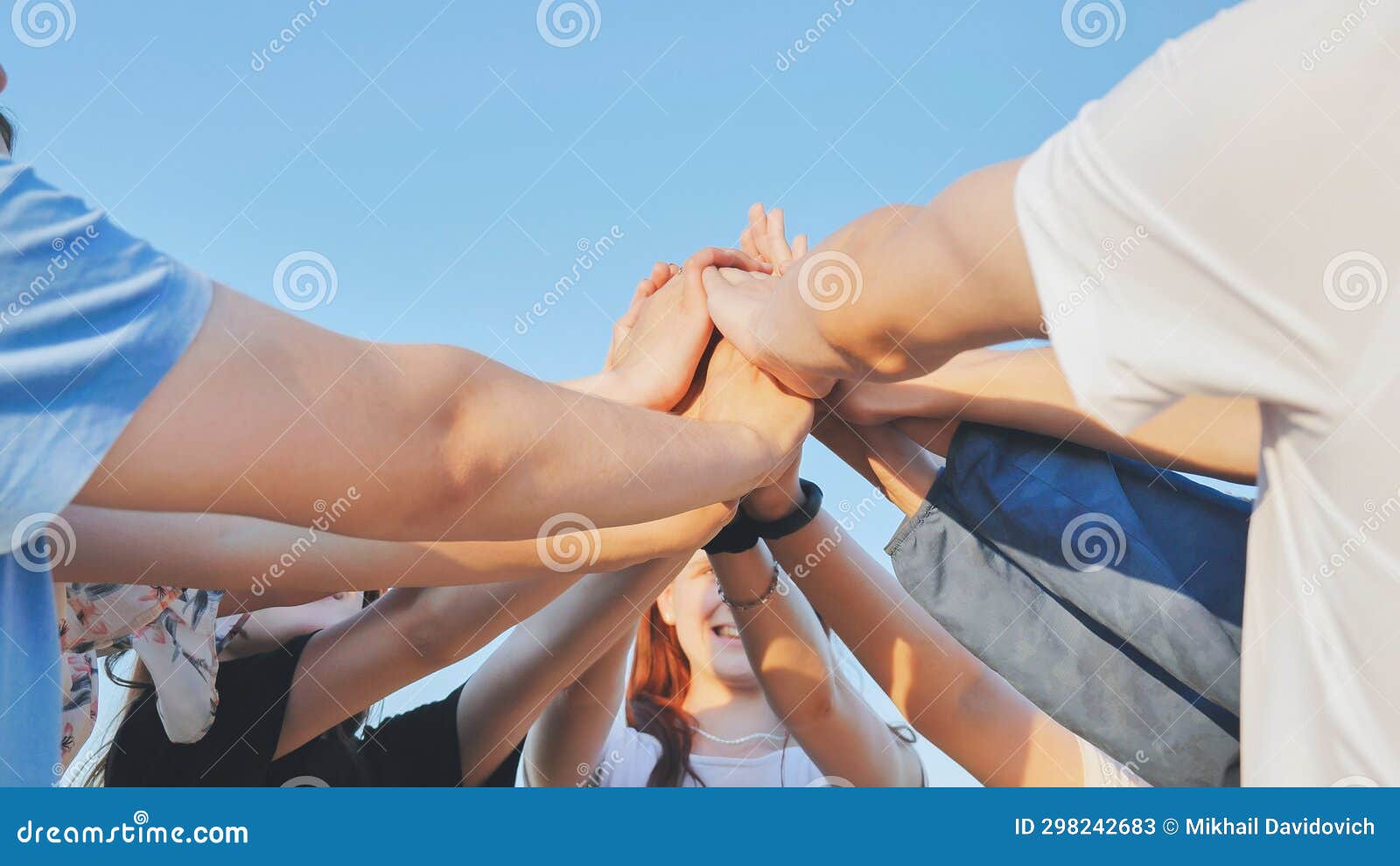Friends Putting Their Hands Together in a Sign of Unity and Teamwork ...