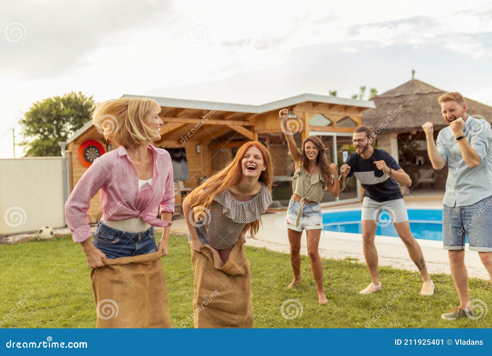 Friends Racing by Jumping in Sacks in the Backyard Stock Image - Image ...
