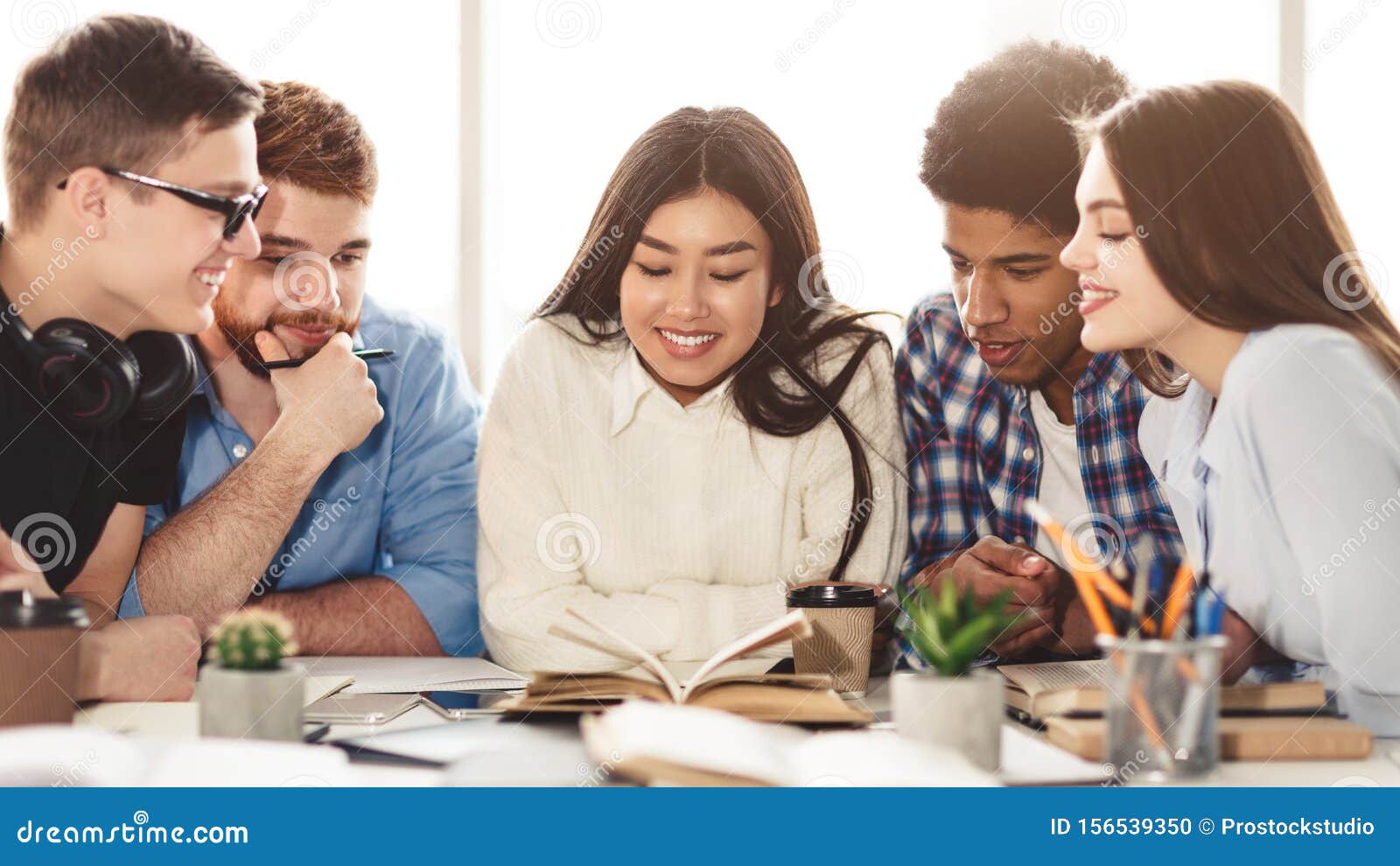 Friends Reading Book in University Library, Searching Information Stock ...
