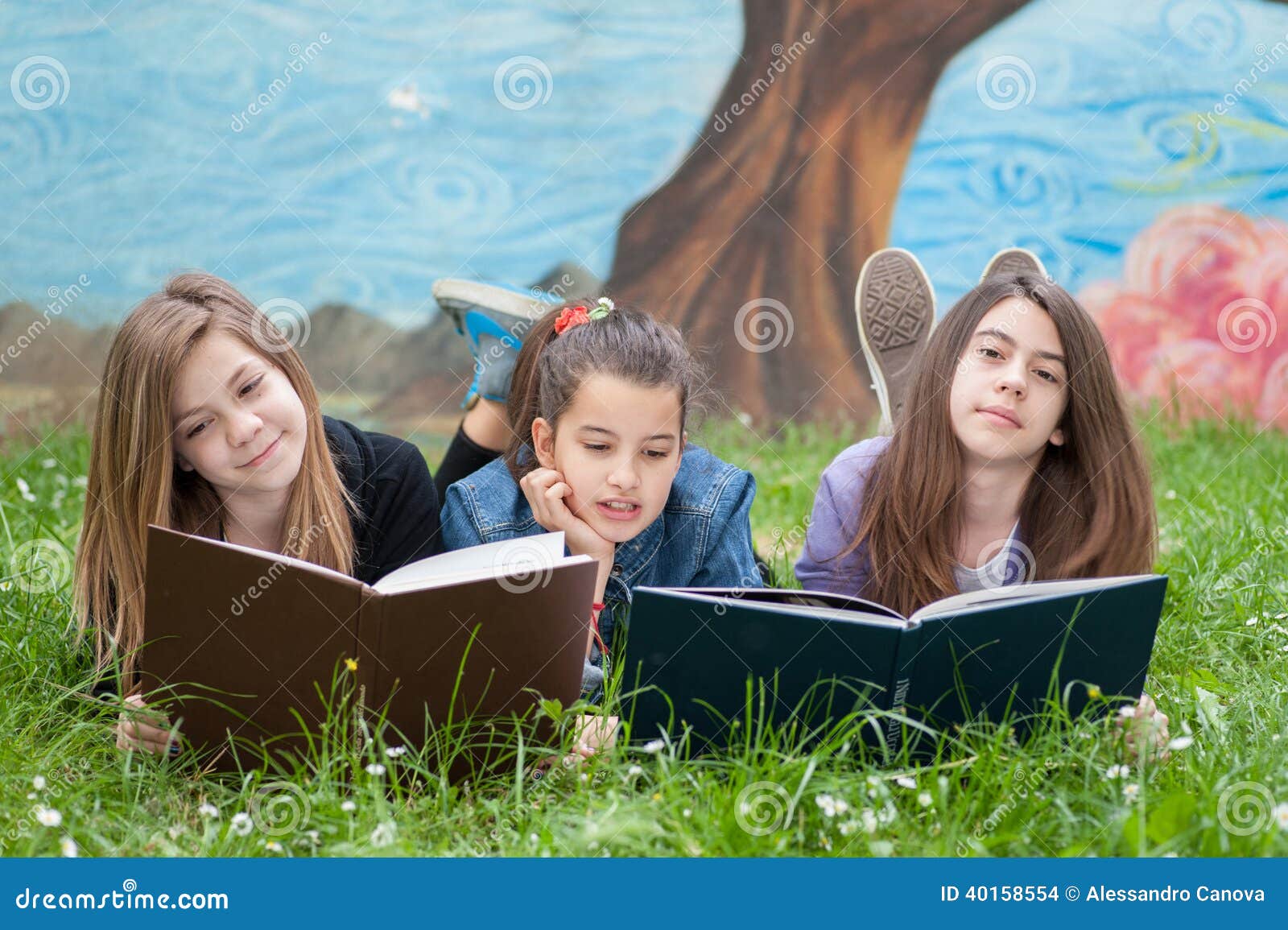 Friends reading books stock photo. Image of lying, grass - 40158554