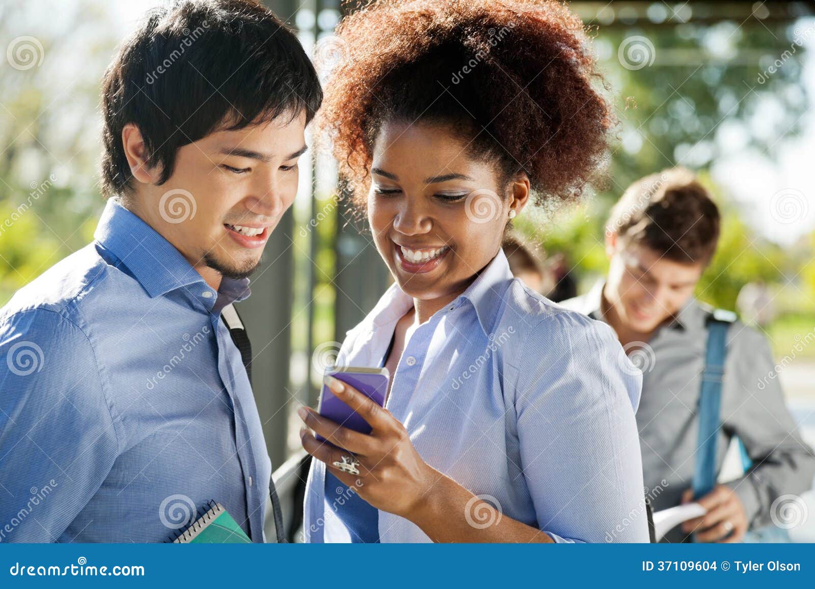 Friends Reading Text Message on Cellphone in Stock Photo - Image of ...