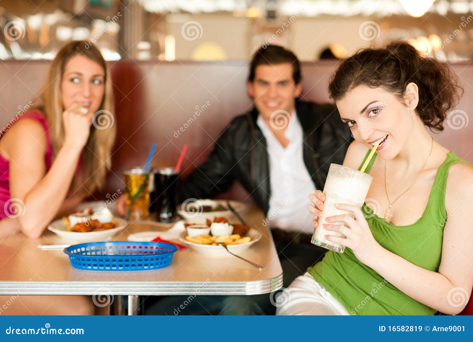 Friends in Restaurant Eating Fast Food Stock Image - Image of holding ...