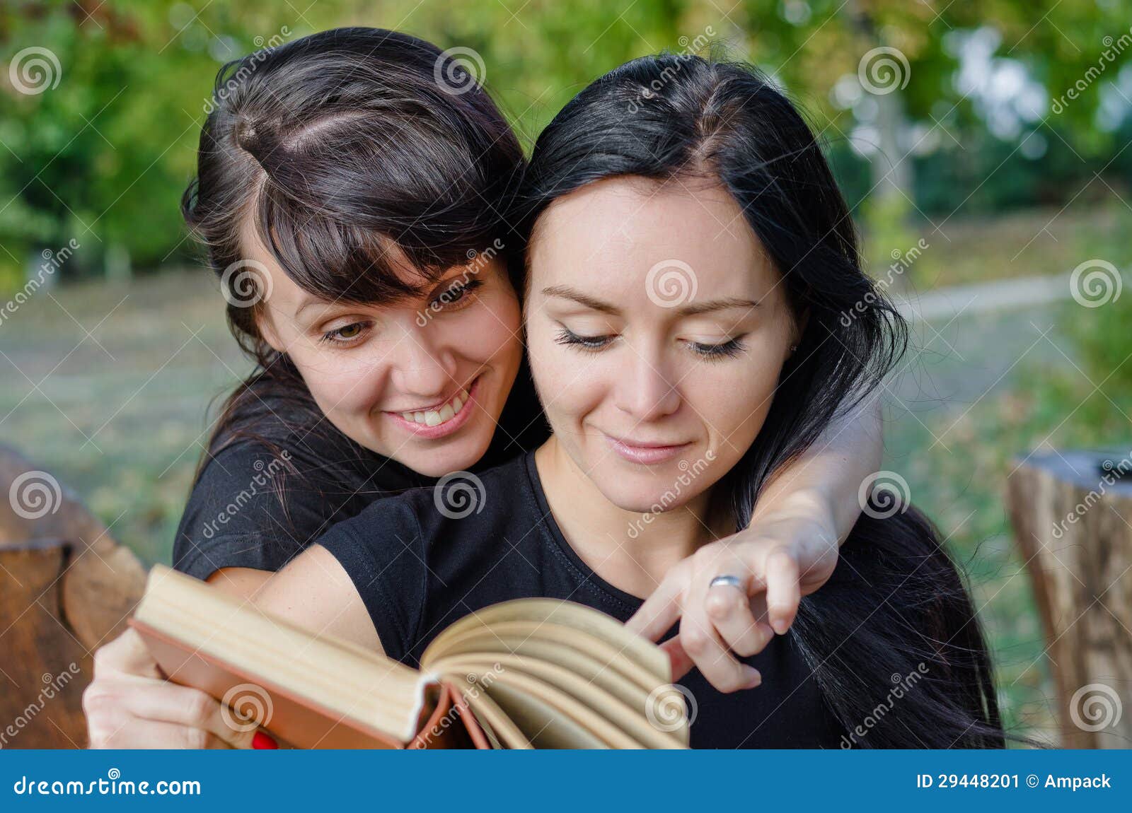 Friends sharing a book stock image. Image of outdoors - 29448201