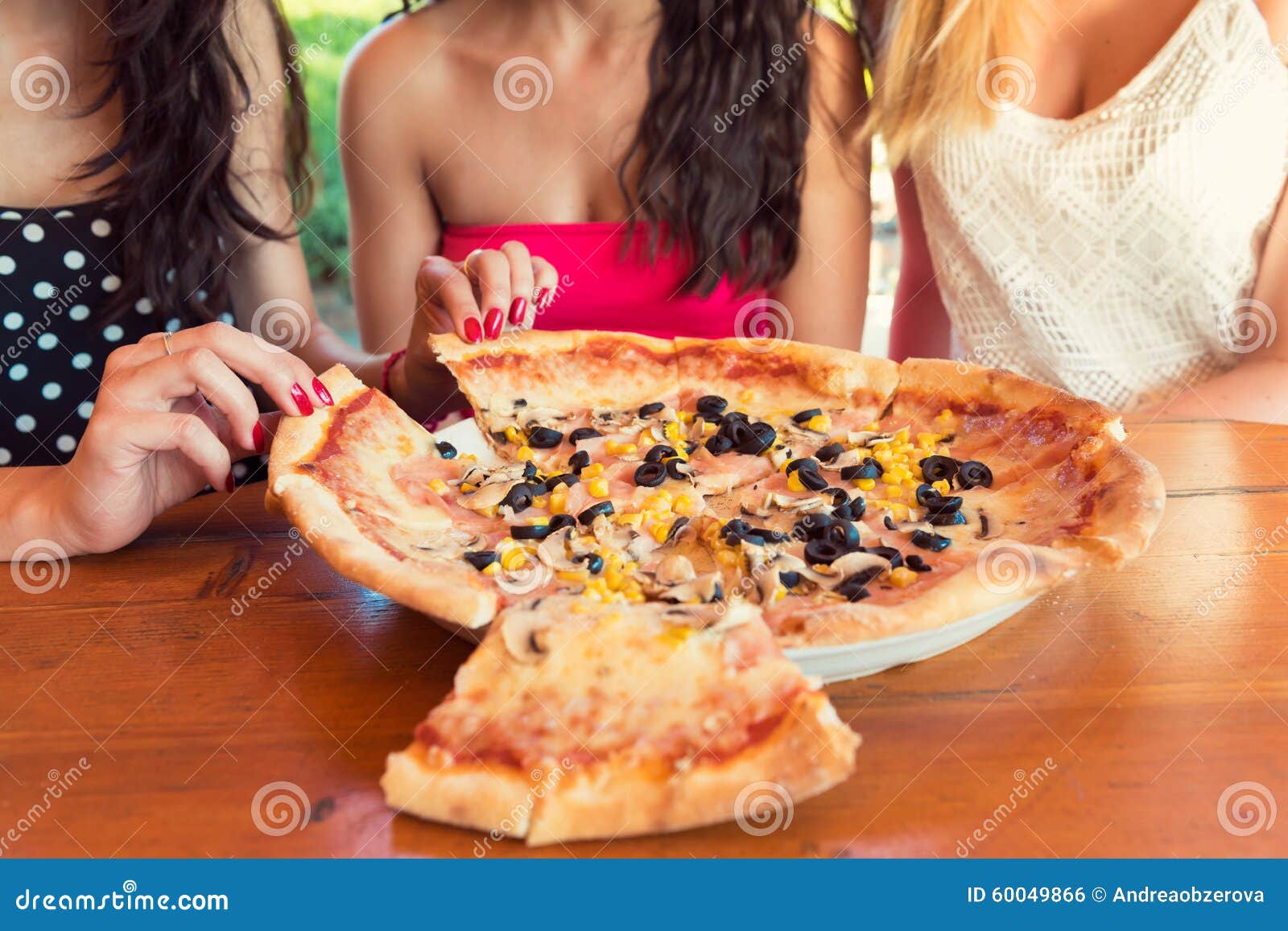 Friends sharing a pizza stock photo. Image of dinning - 60049866