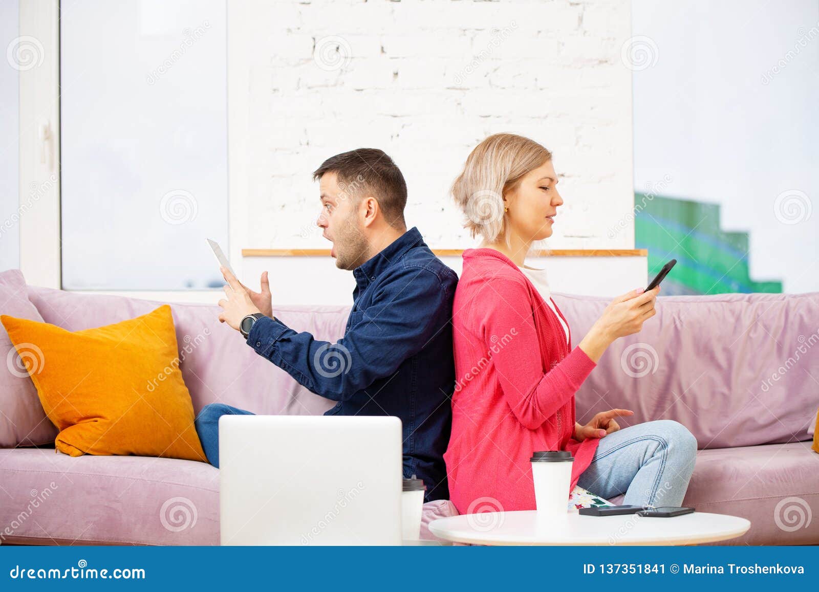 Friends Sit on the Couch, Chatting and Using a Smartphone, Desktop ...