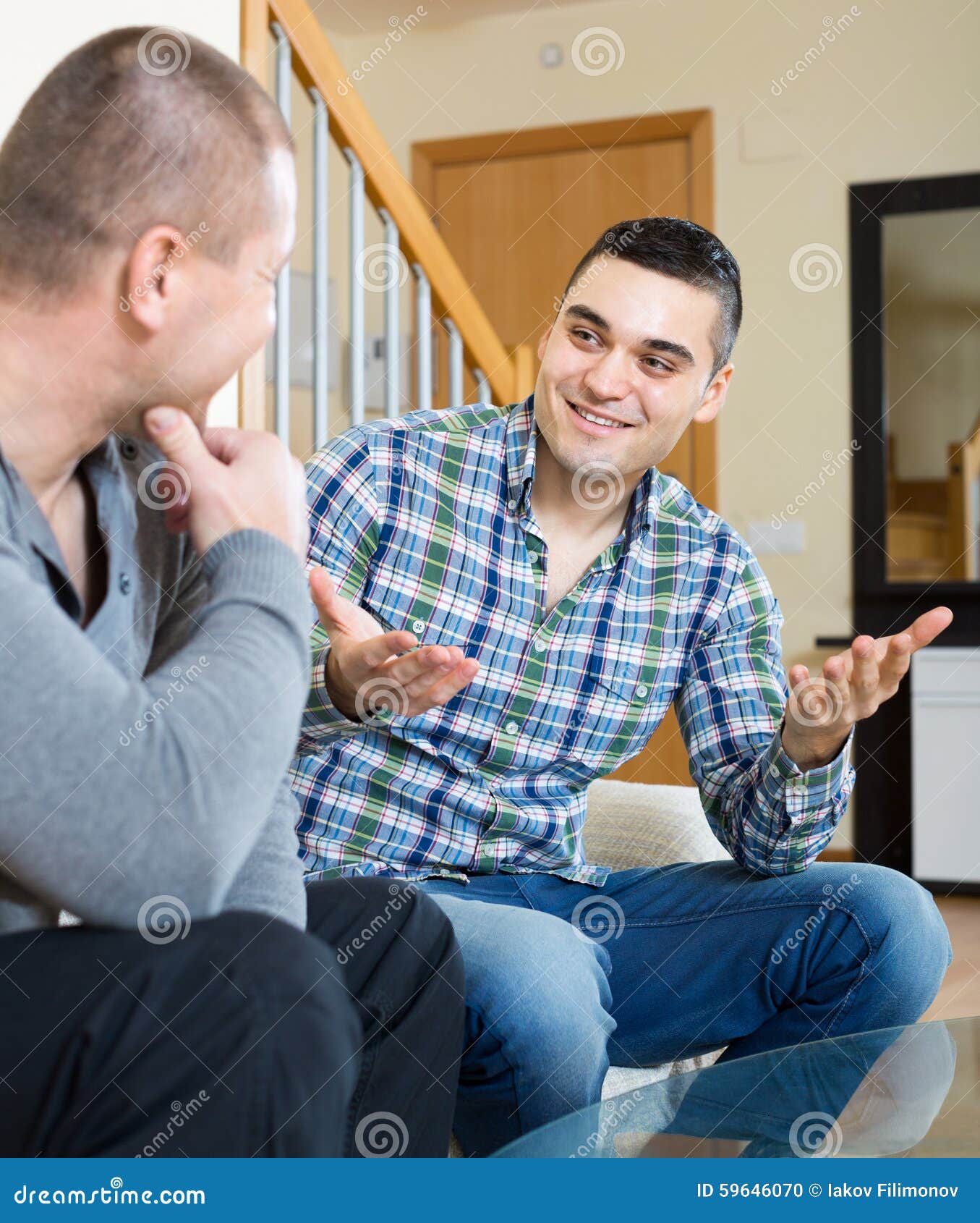 Friends sitting on couch stock photo. Image of buddy - 59646070
