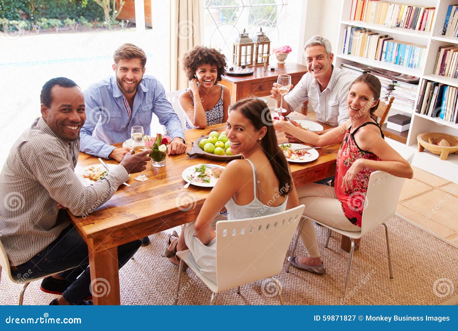 Friends Sitting at a Dining Table Looking at the Camera Stock Image ...