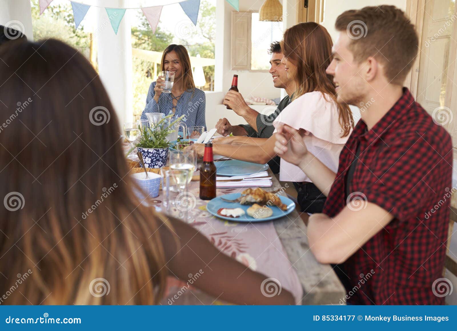 Friends Sitting at a Dinner Party on a Patio, Close Up Stock Image ...