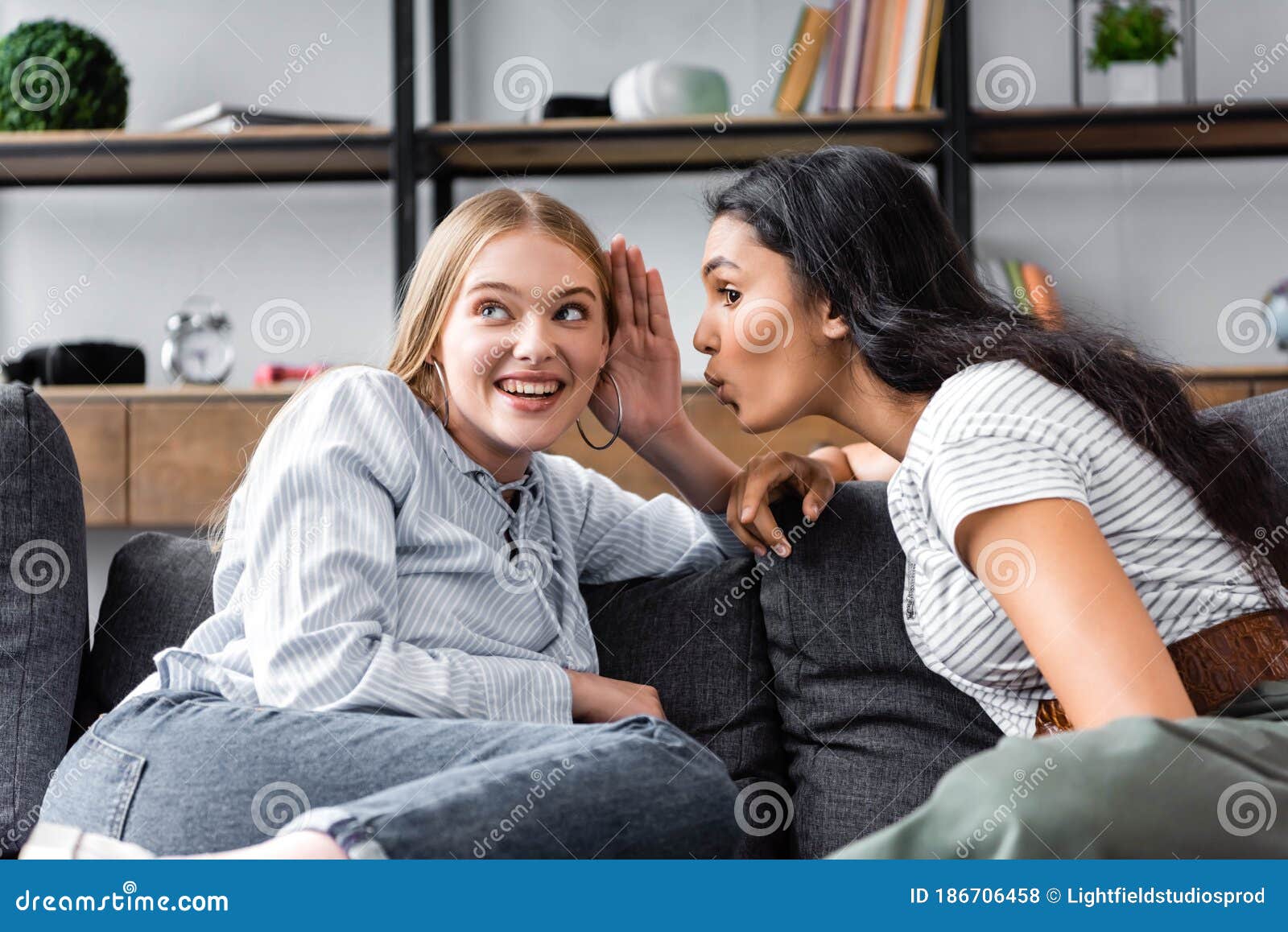 Friends Sitting on Sofa and Smiling in Apartment Stock Photo - Image of ...