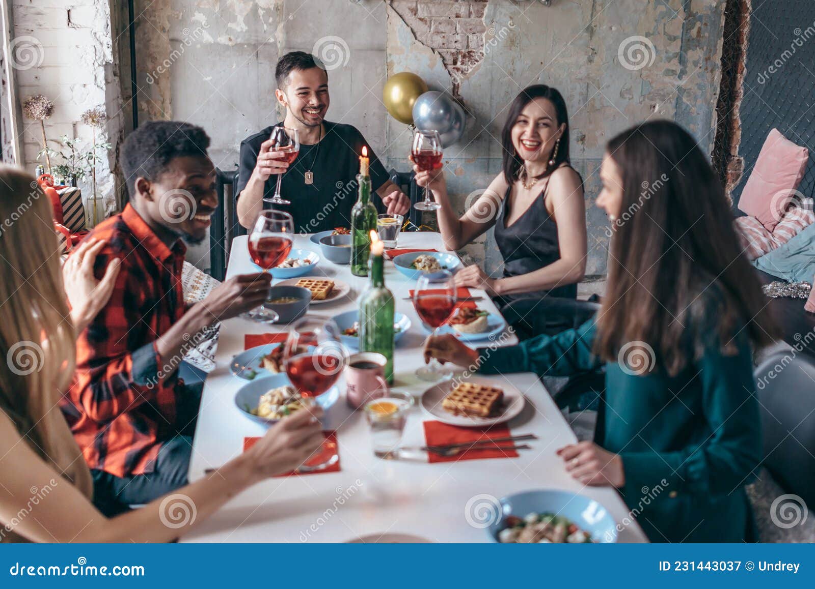 Friends Sitting at a Table Drinking Wine Clinking Glasses Stock Image ...