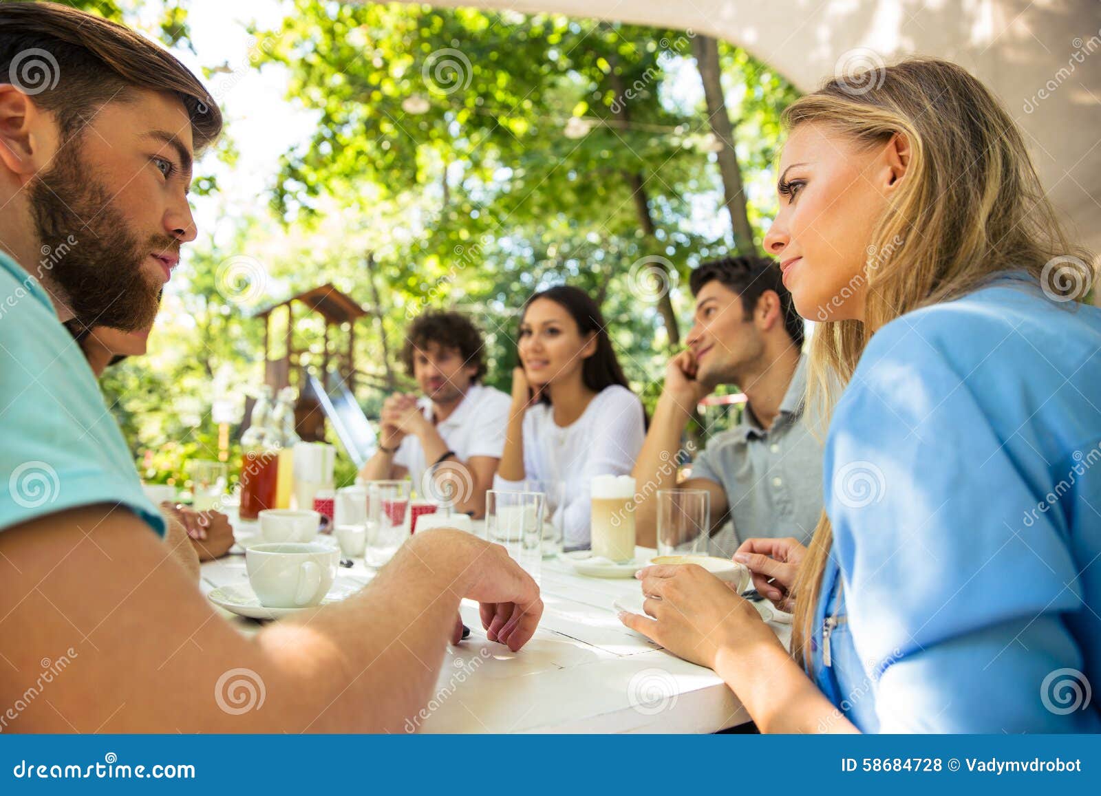 Friends Sitting at the Table in Outdoor Restaurant Stock Photo - Image ...