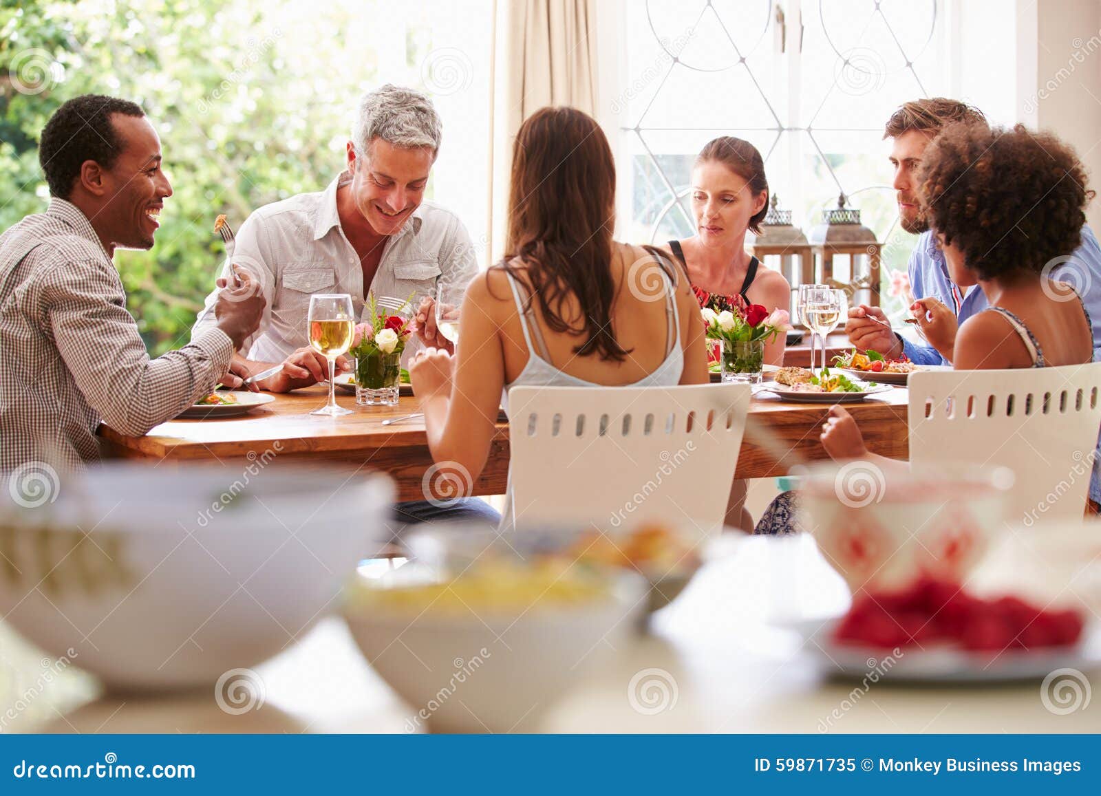 Friends Sitting at a Table Talking during a Dinner Party Stock Image ...