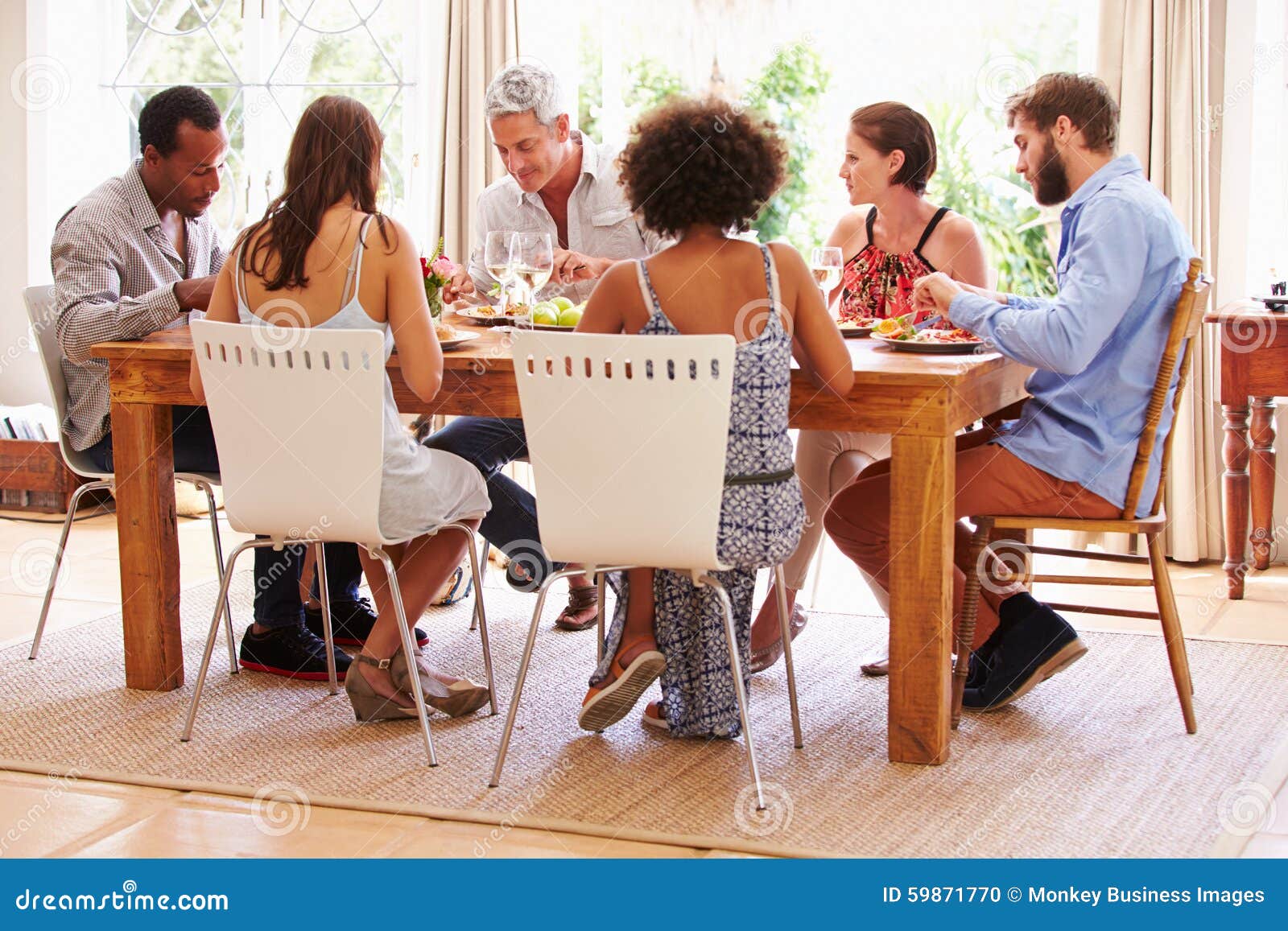 Friends Sitting at a Table Talking during a Dinner Party Stock Photo ...