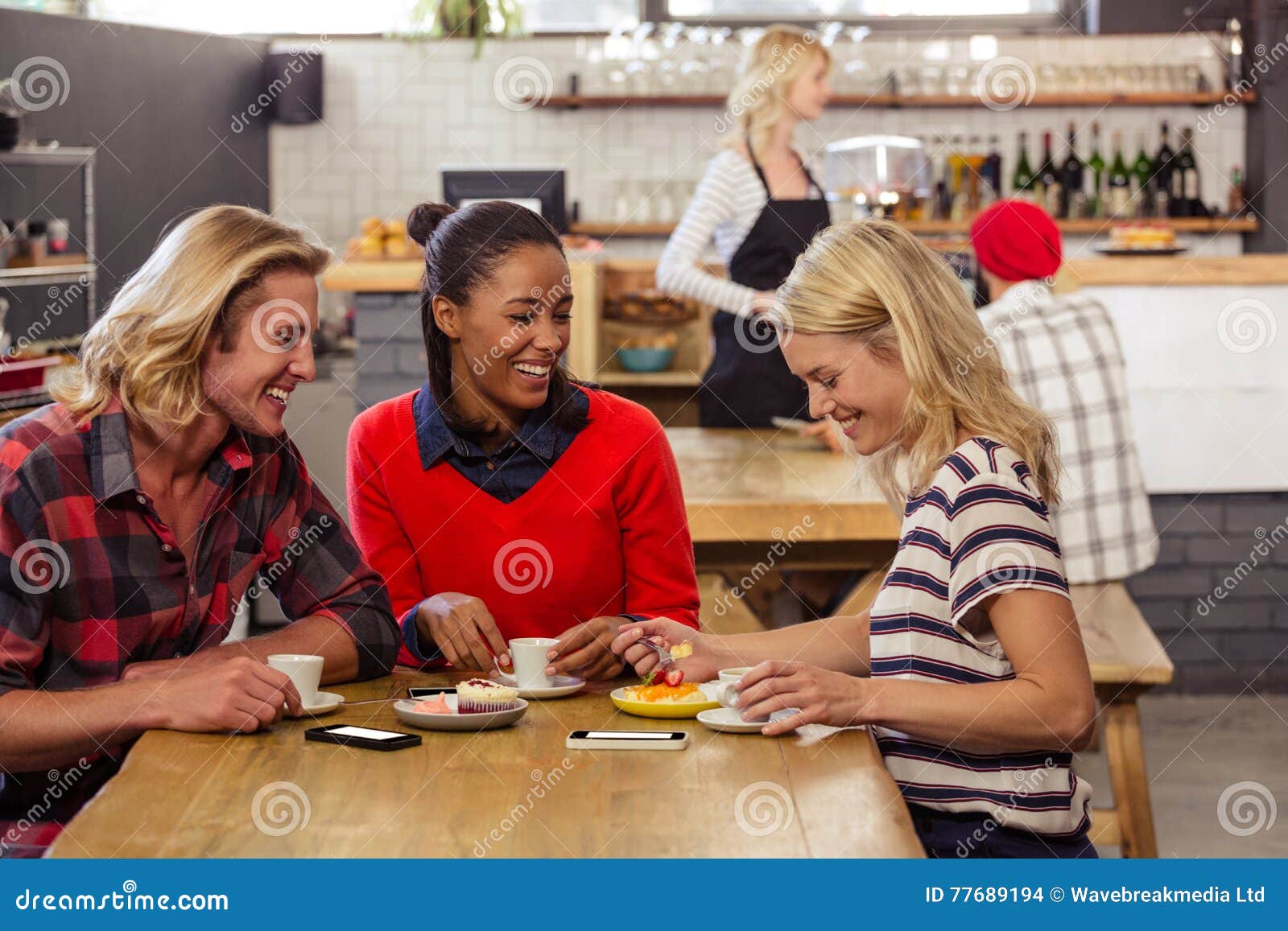 Friends sitting together stock photo. Image of coffee - 77689194