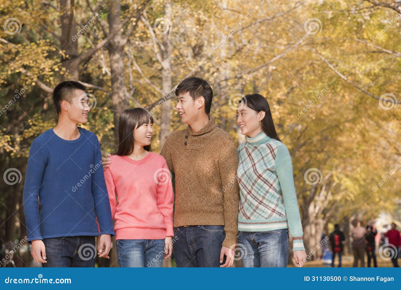 Friends Smiling and Walking Together in Park in Autumn Stock Photo ...