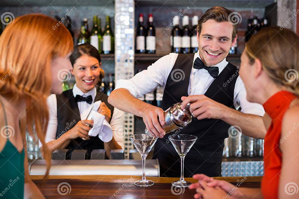 Friends Standing at Counter while Bartender Preparing a Drink Stock ...