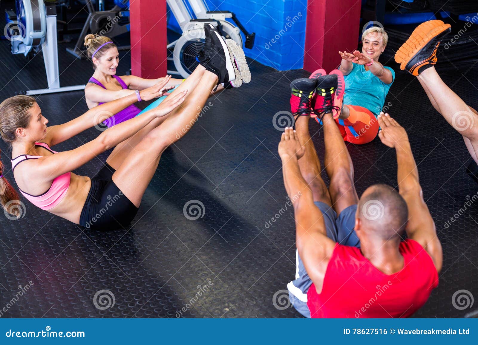 Friends stretching in gym stock photo. Image of mixedrace - 78627516