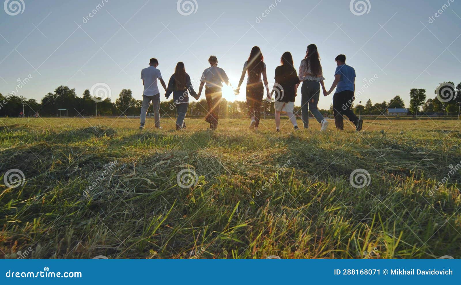 Friends at Sunset Holding Hands Walking Towards the Sun. Stock Video ...