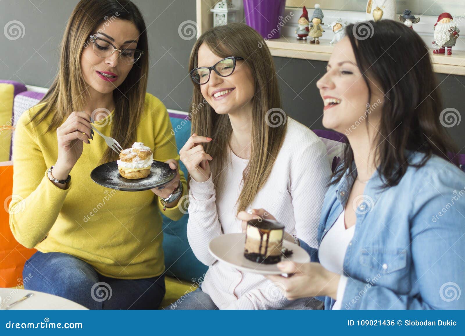 Friends talk and eat cakes stock photo. Image of communication - 109021436