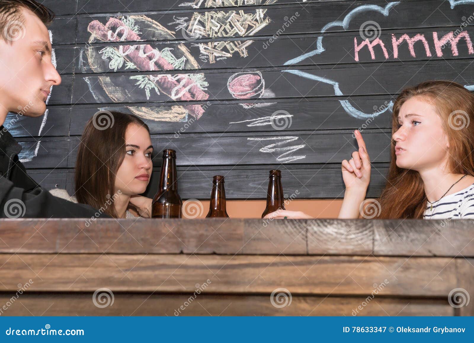 Friends talking in a bar stock image. Image of bottom - 78633347
