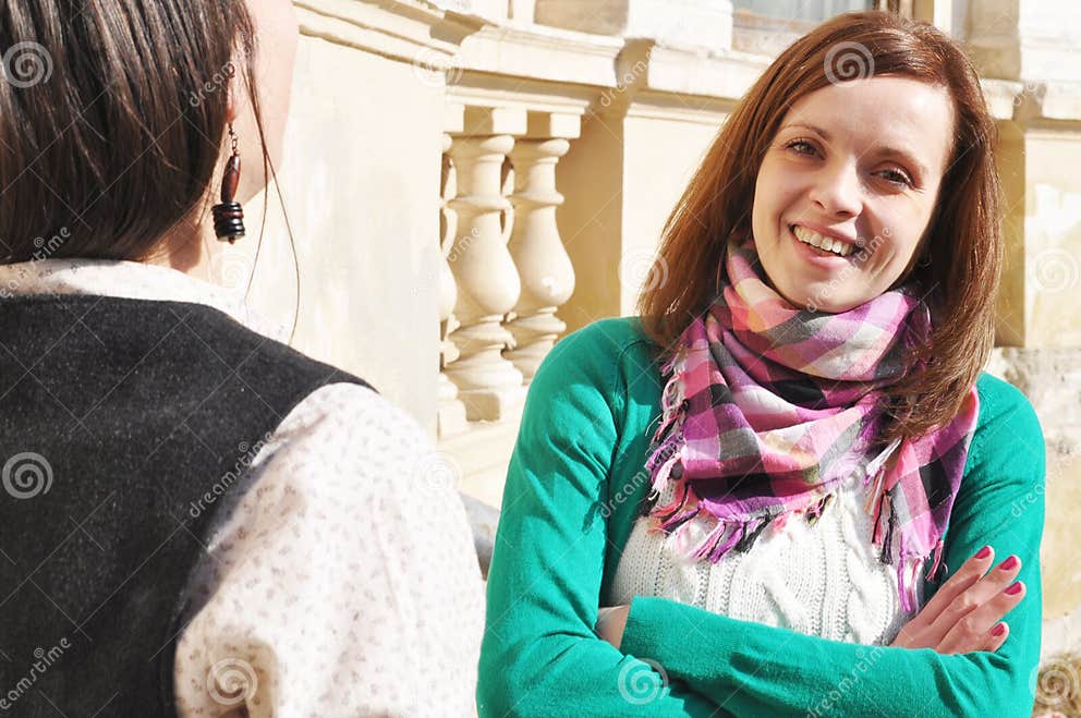 Friends talking outside stock image. Image of friend - 18505153