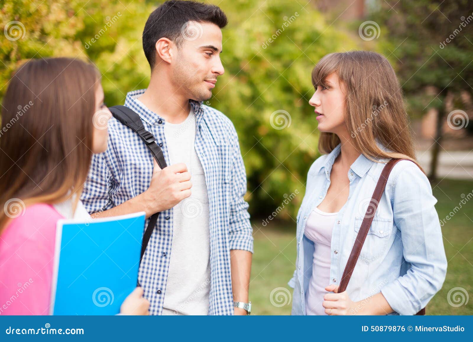 Friends talking in a park stock photo. Image of green - 50879876