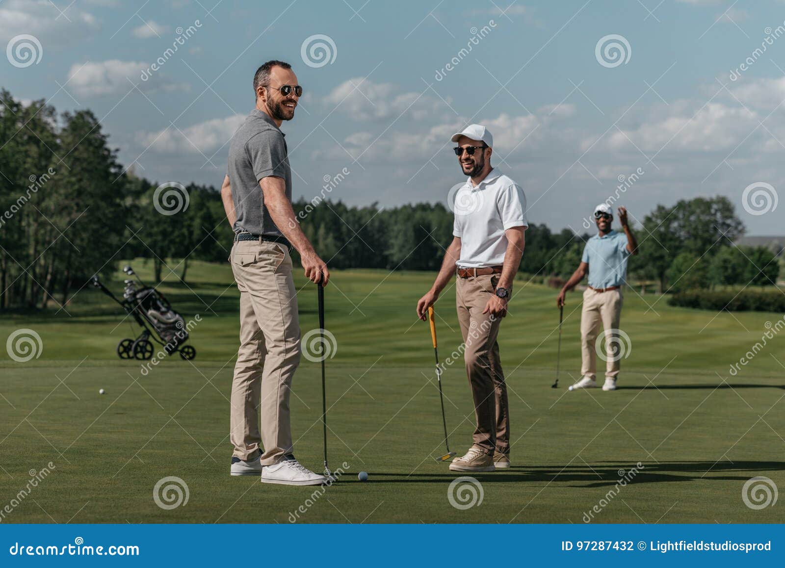 Friends Talking while Playing Golf Together on Green at Daytime Stock ...